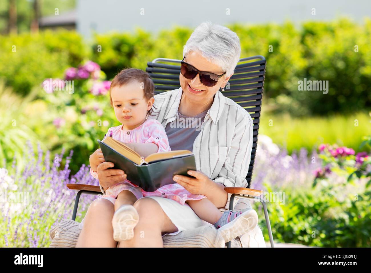 grandmother and baby granddaughter reading book Stock Photo - Alamy