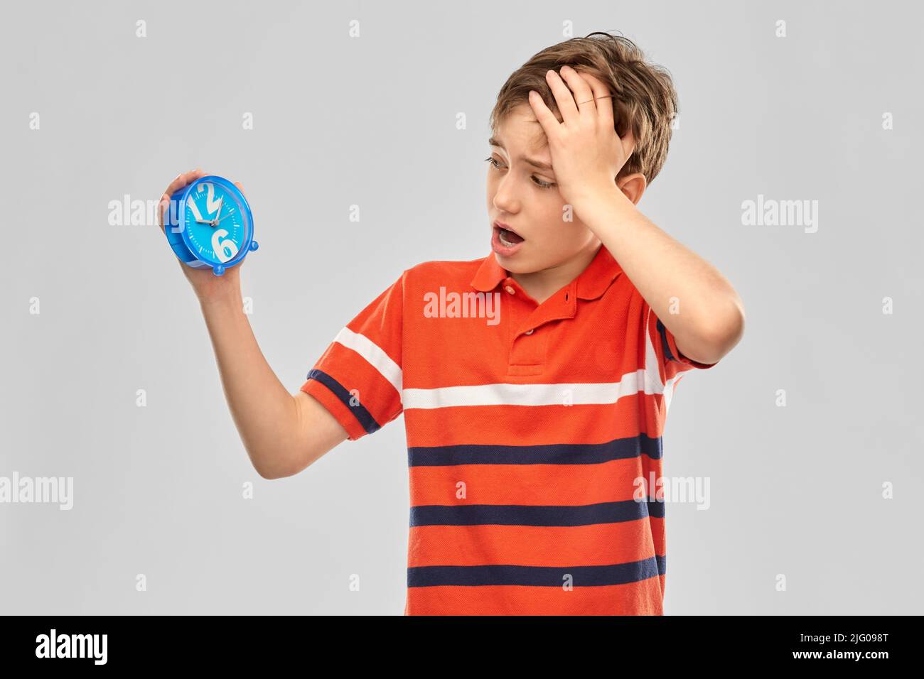 portrait of boy with alarm clock Stock Photo - Alamy