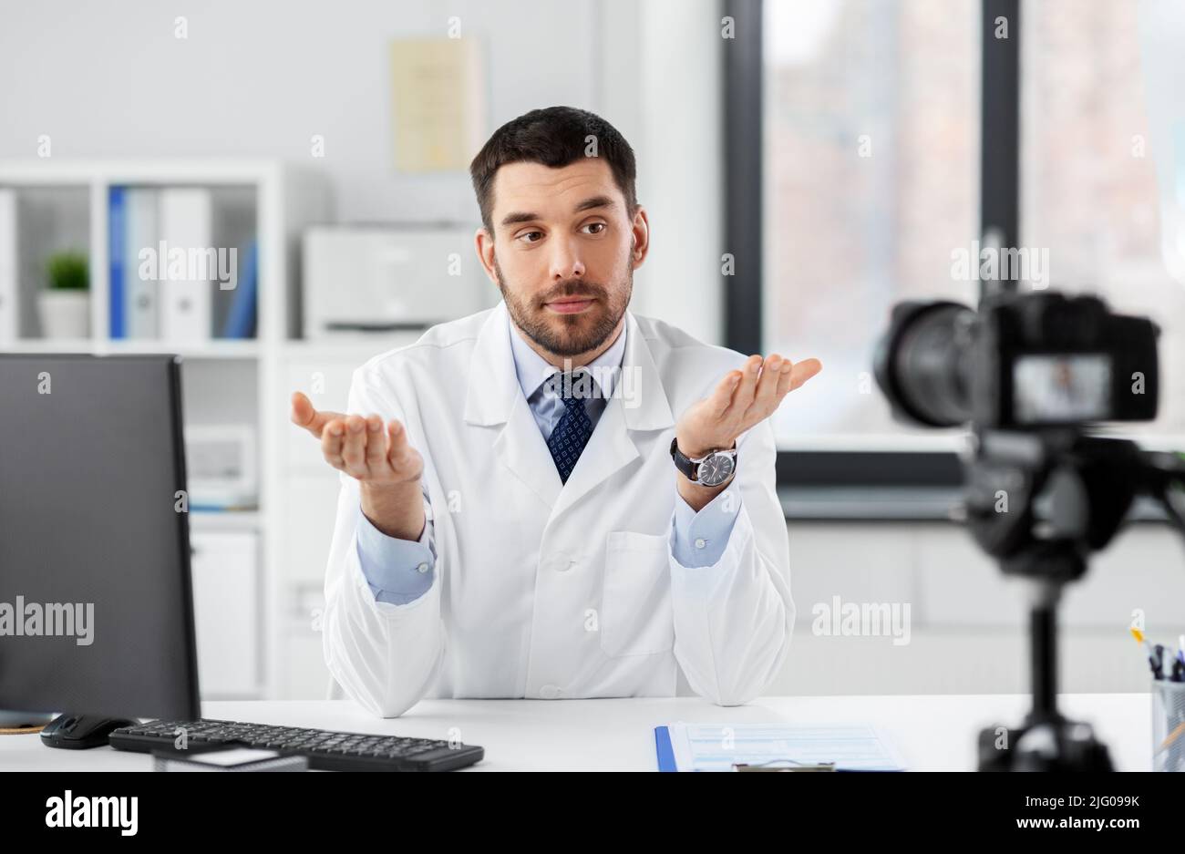 male doctor recording video blog at hospital Stock Photo - Alamy