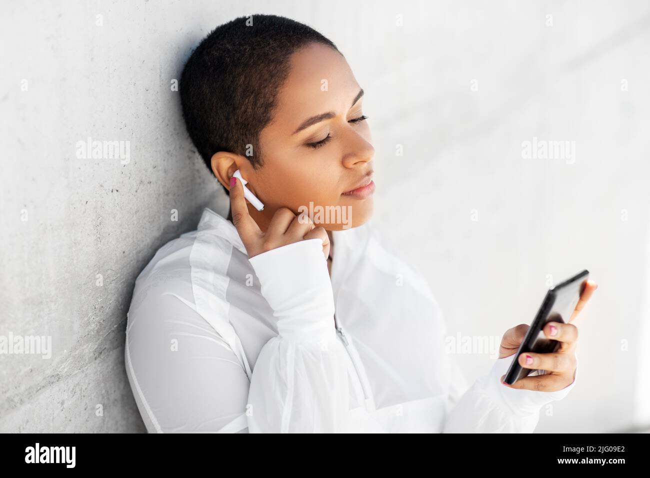 african american woman with earphones and phone Stock Photo - Alamy