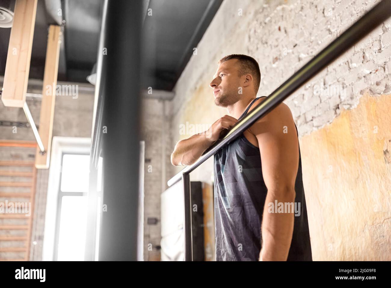 young man at parallel bars in gym Stock Photo - Alamy