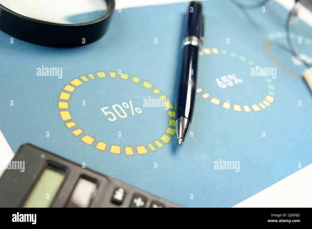 financial graph, calculator and notepad on table Stock Photo - Alamy