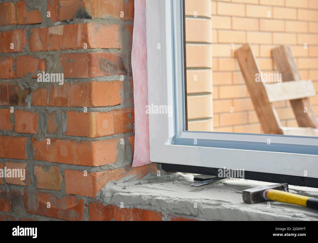 Windows installation. Inserting a upvc plastic window frame in a newly ...