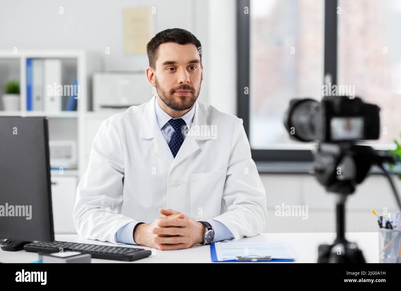 male doctor recording video blog at hospital Stock Photo - Alamy