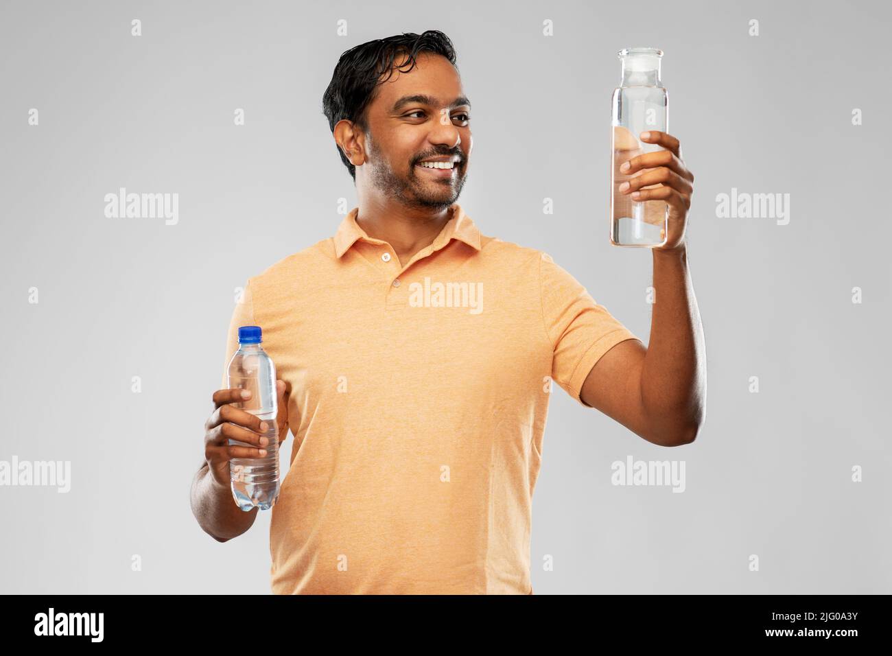 indian man comparing water in different bottles Stock Photo - Alamy
