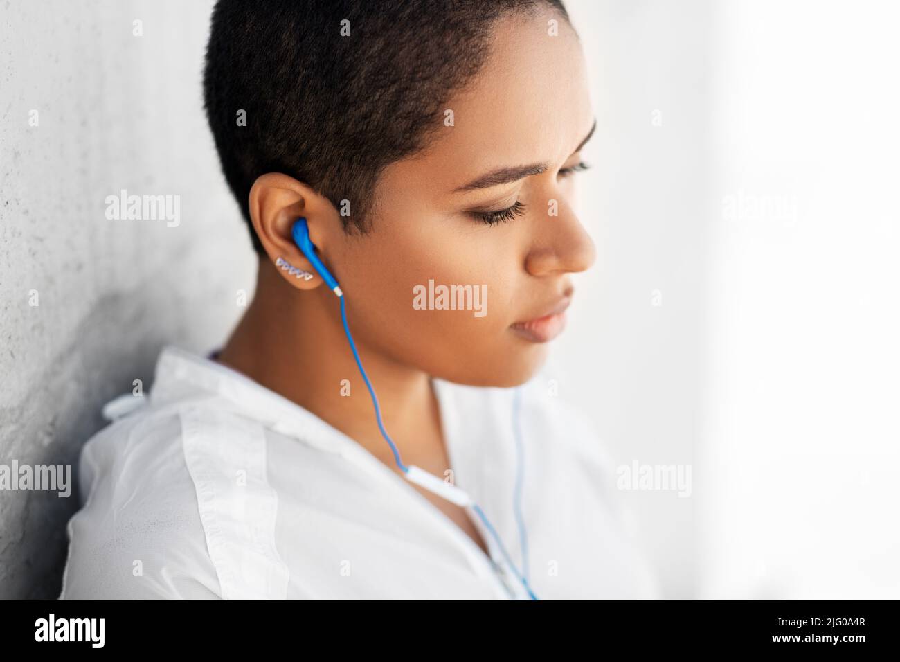 Beautiful woman white earphones hi-res stock photography and images - Alamy