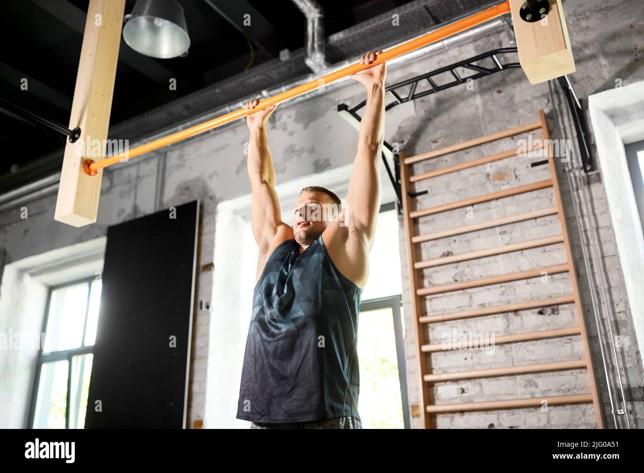 man exercising on bar and doing pull-ups in gym Stock Photo - Alamy