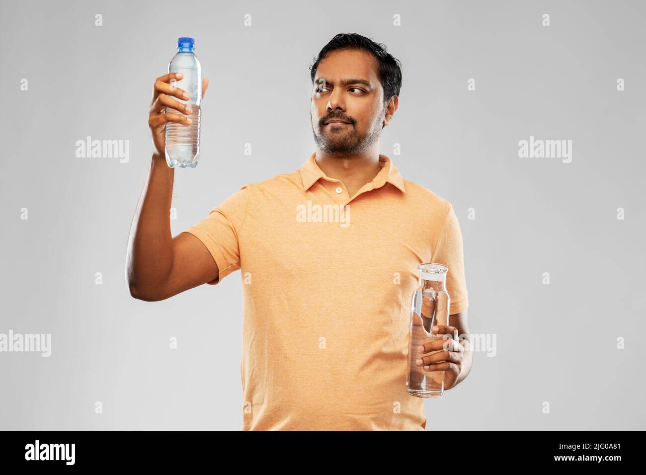 indian man comparing water in different bottles Stock Photo - Alamy