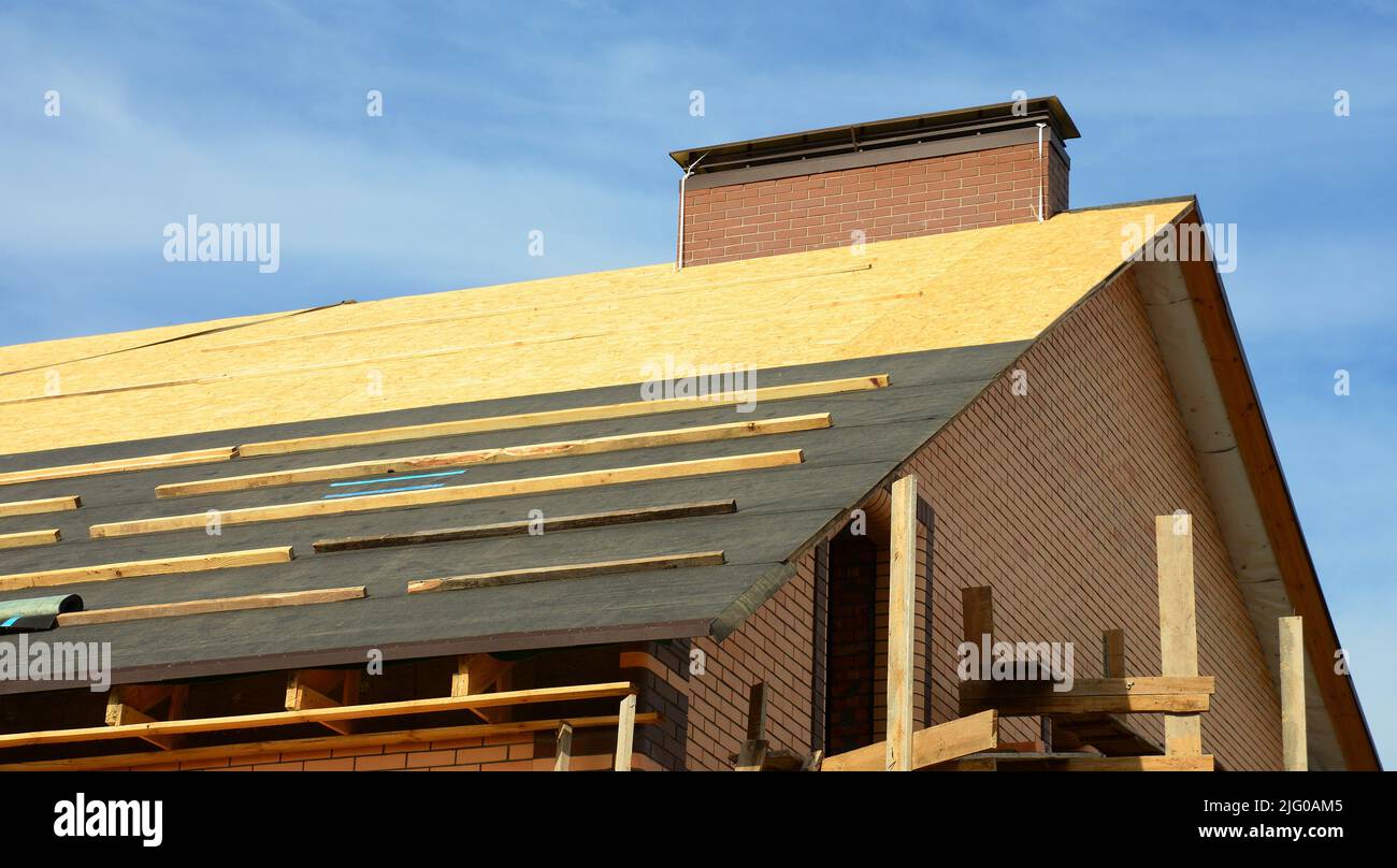 Roofing construction on the stage of roofing underlayment installation ...