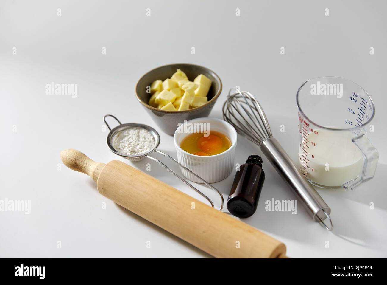 rolling pin, butter, eggs, flour, milk and whisk Stock Photo - Alamy