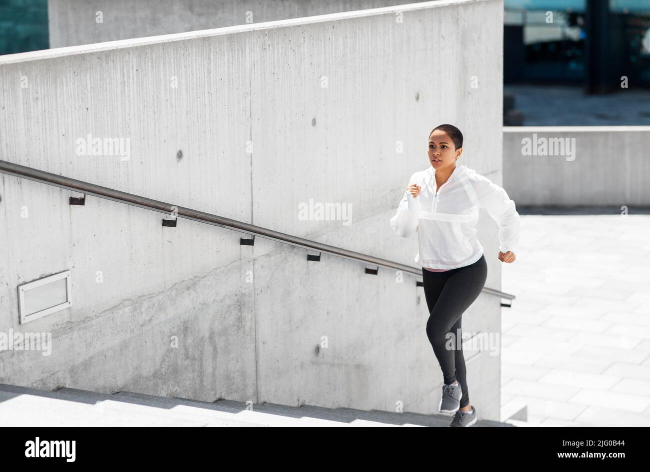 Black woman running up stairs hi-res stock photography and images - Alamy
