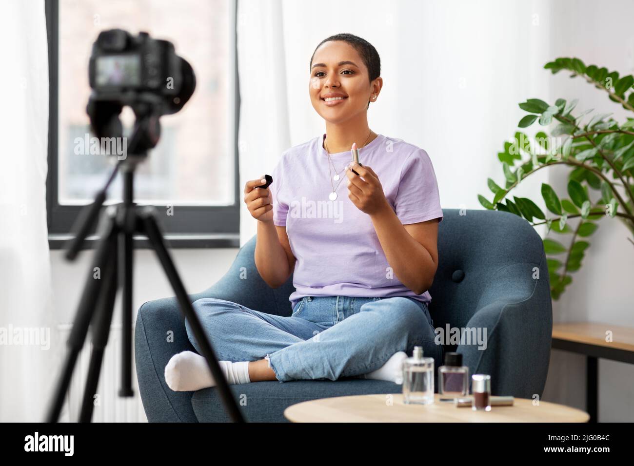 female beauty blogger with camera and lipstick Stock Photo - Alamy