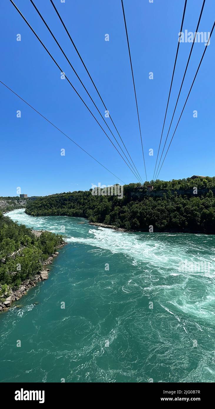 A vertical shot of a wide tropic river on a bright cloudless day Stock ...