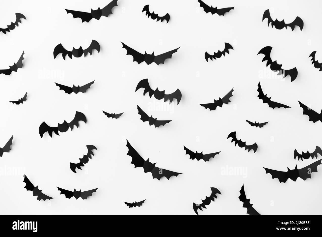 flock of black paper bats over white background Stock Photo - Alamy