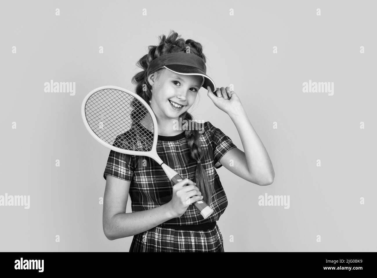 sport teen kid in fitness cap holding tennis or badminton racket ...