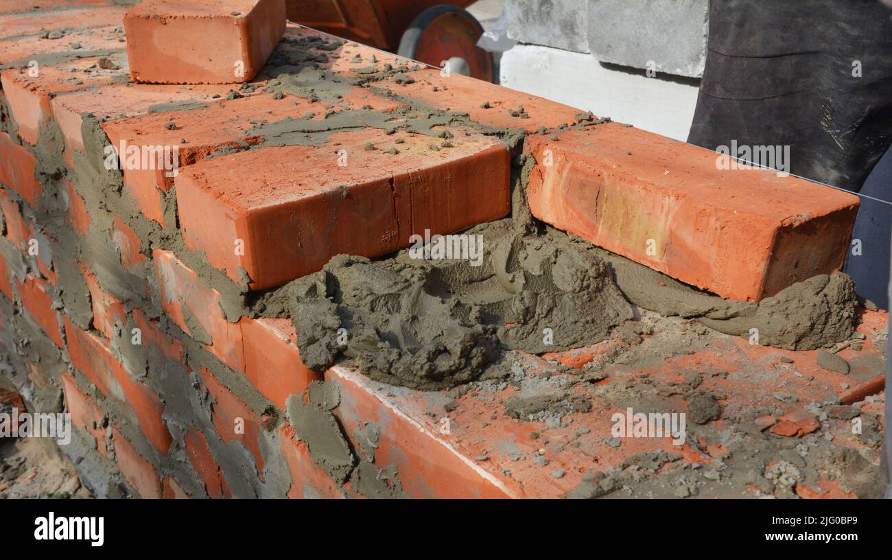Brick wall house construction site Stock Photo - Alamy