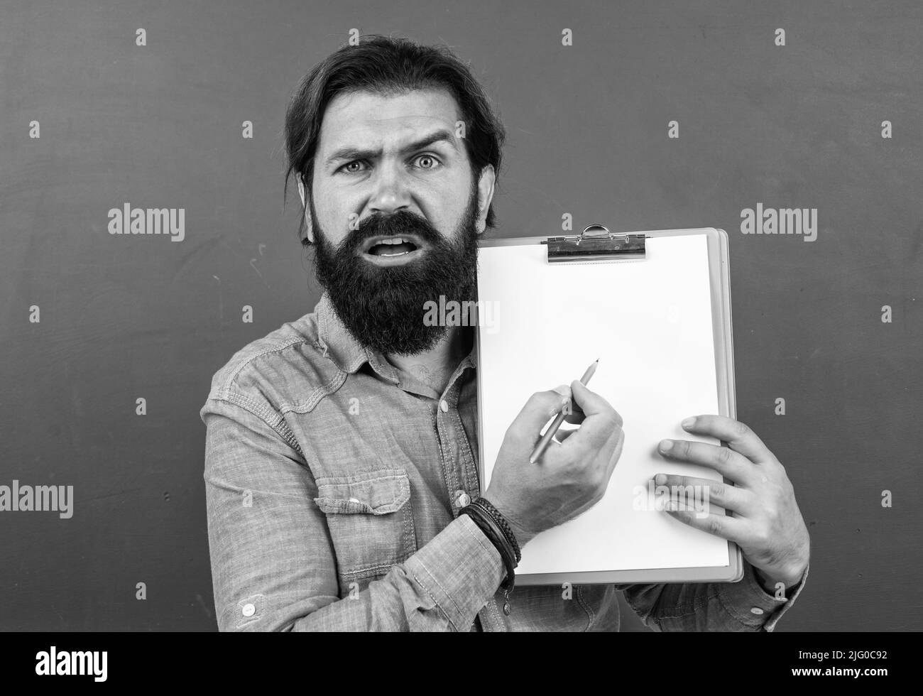 good looking male with beard and moustache showing document paper for ...