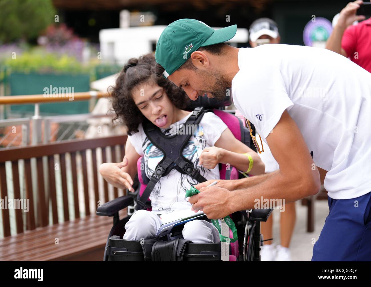 Novak Djokovic signs an autograph for a fan on day ten of the 2022 ...