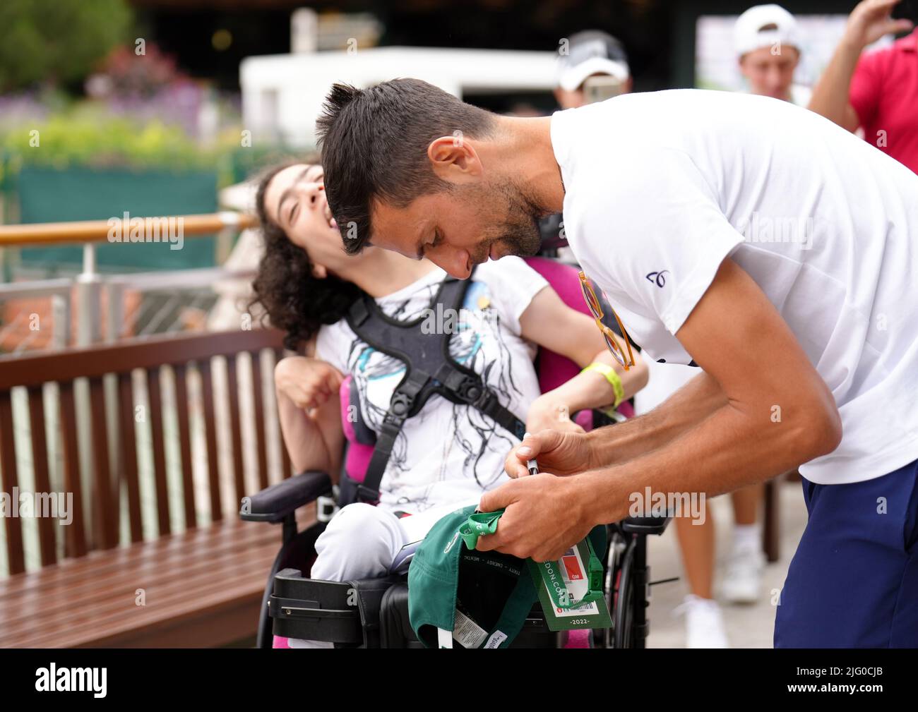 Novak Djokovic signs an autograph for a fan on day ten of the 2022 ...