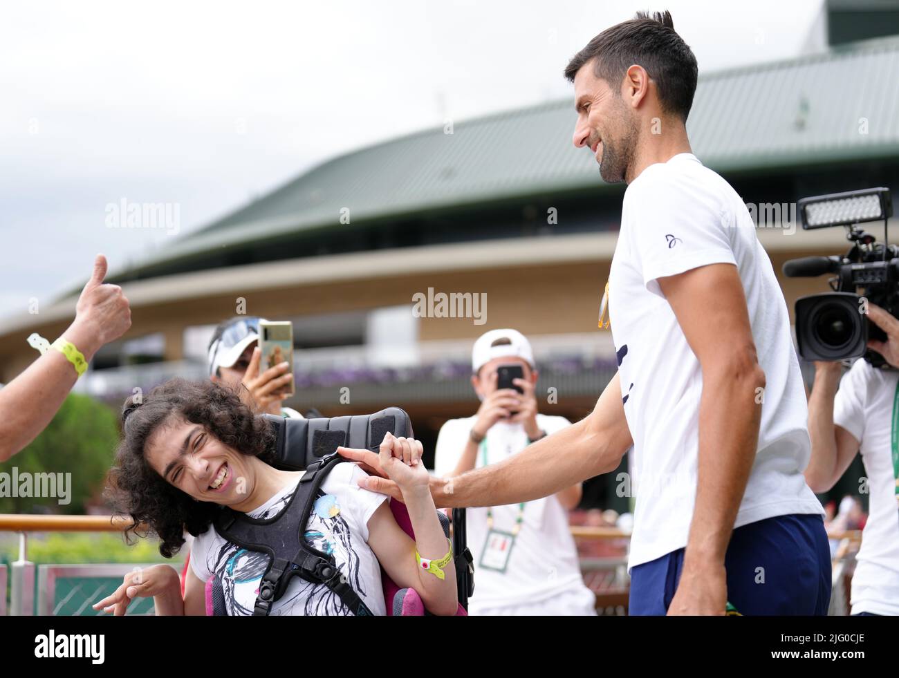 Novak Djokovic greets a fan on day ten of the 2022 Wimbledon ...