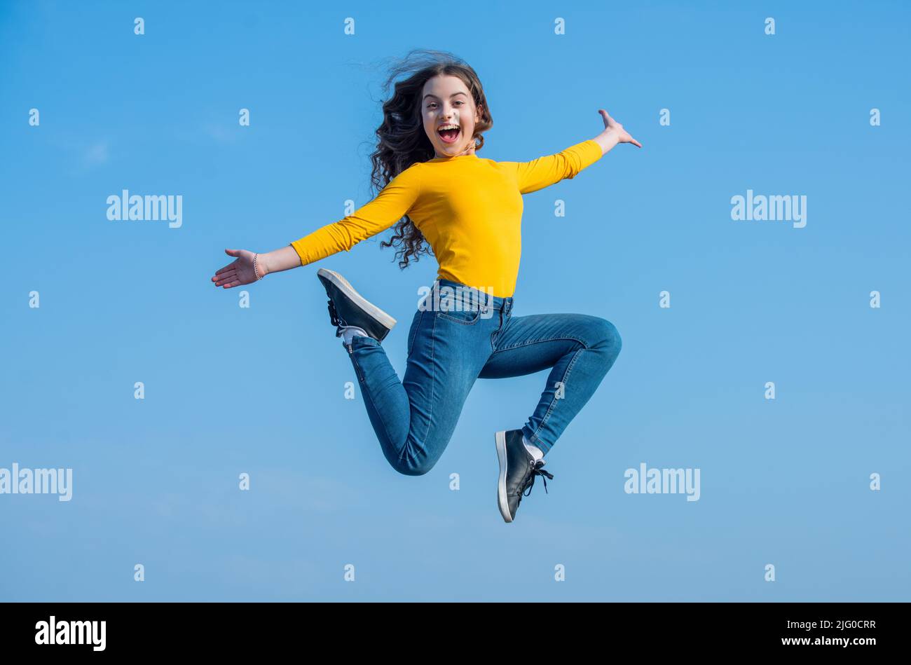 rejoicing teen girl jump high on sky background Stock Photo - Alamy