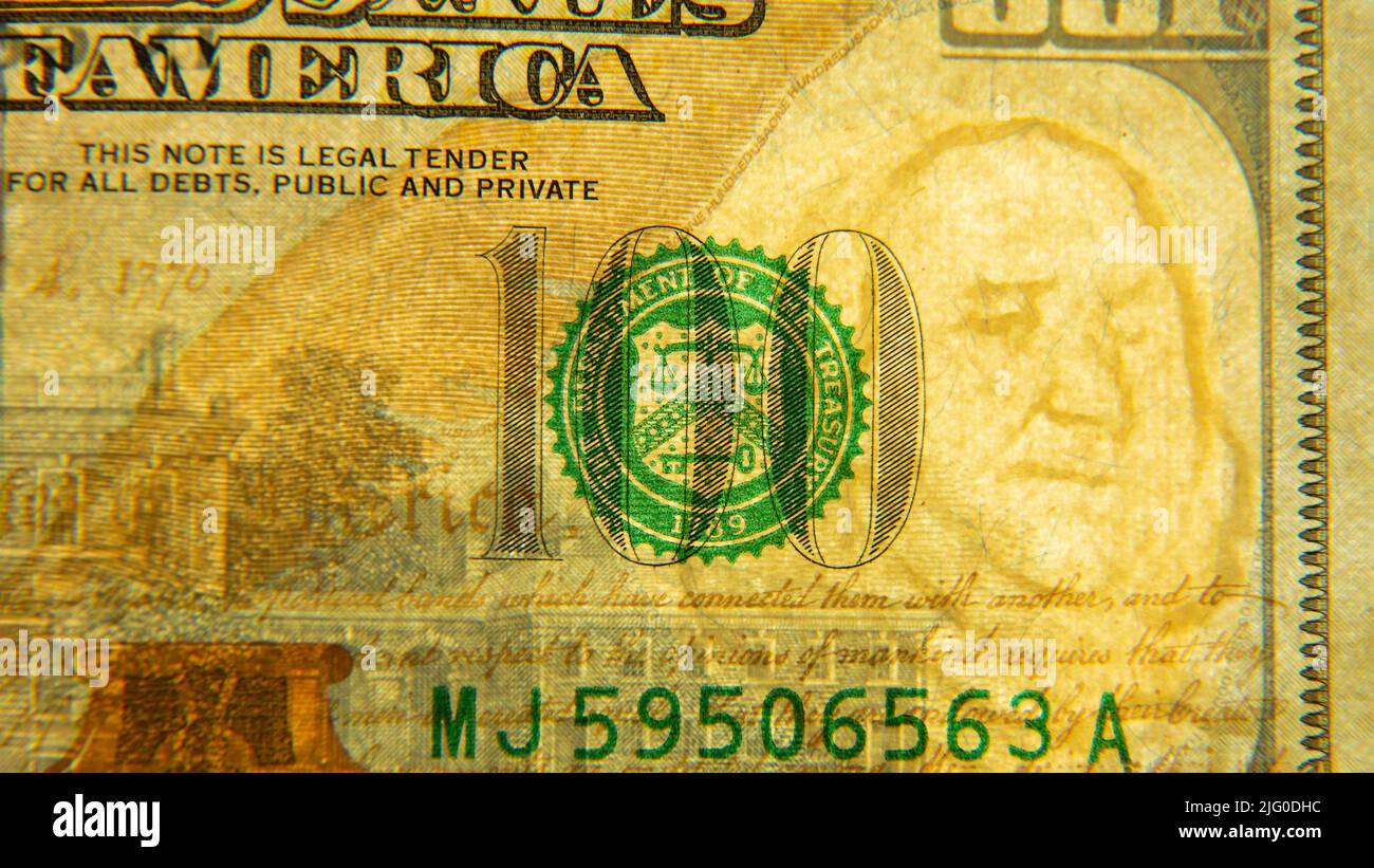 A hundred-dollar bill in close-up with a watermark. Verifying the ...