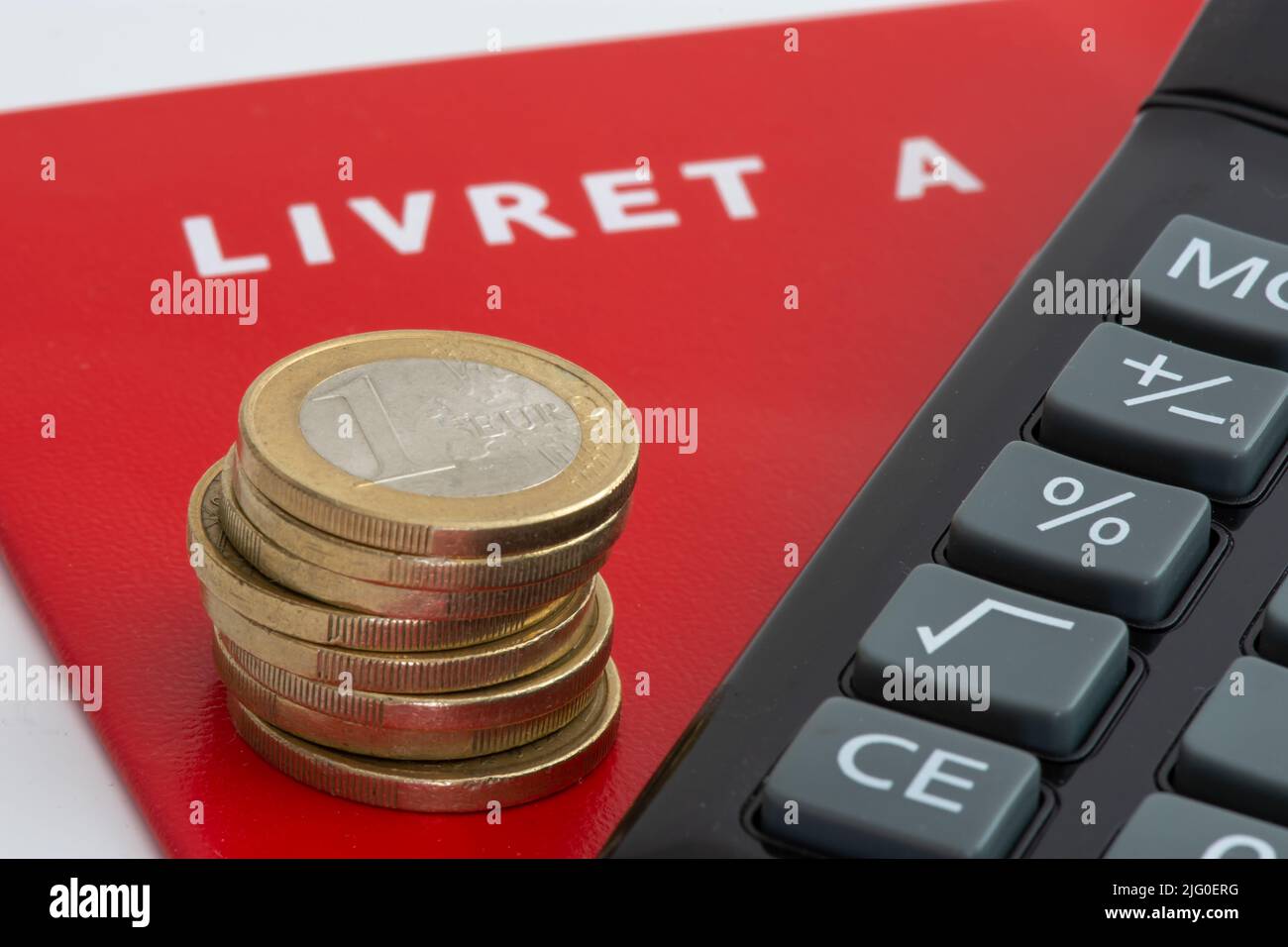 France: Livret A booklet with a stack of euro coins and a calculator ...