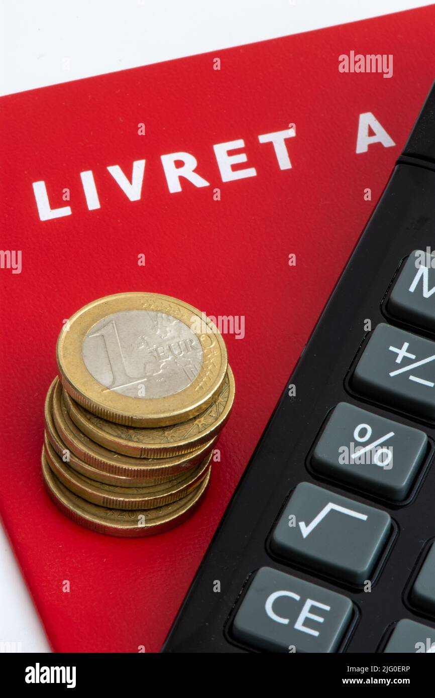 France: Livret A booklet with a stack of euro coins and a calculator ...