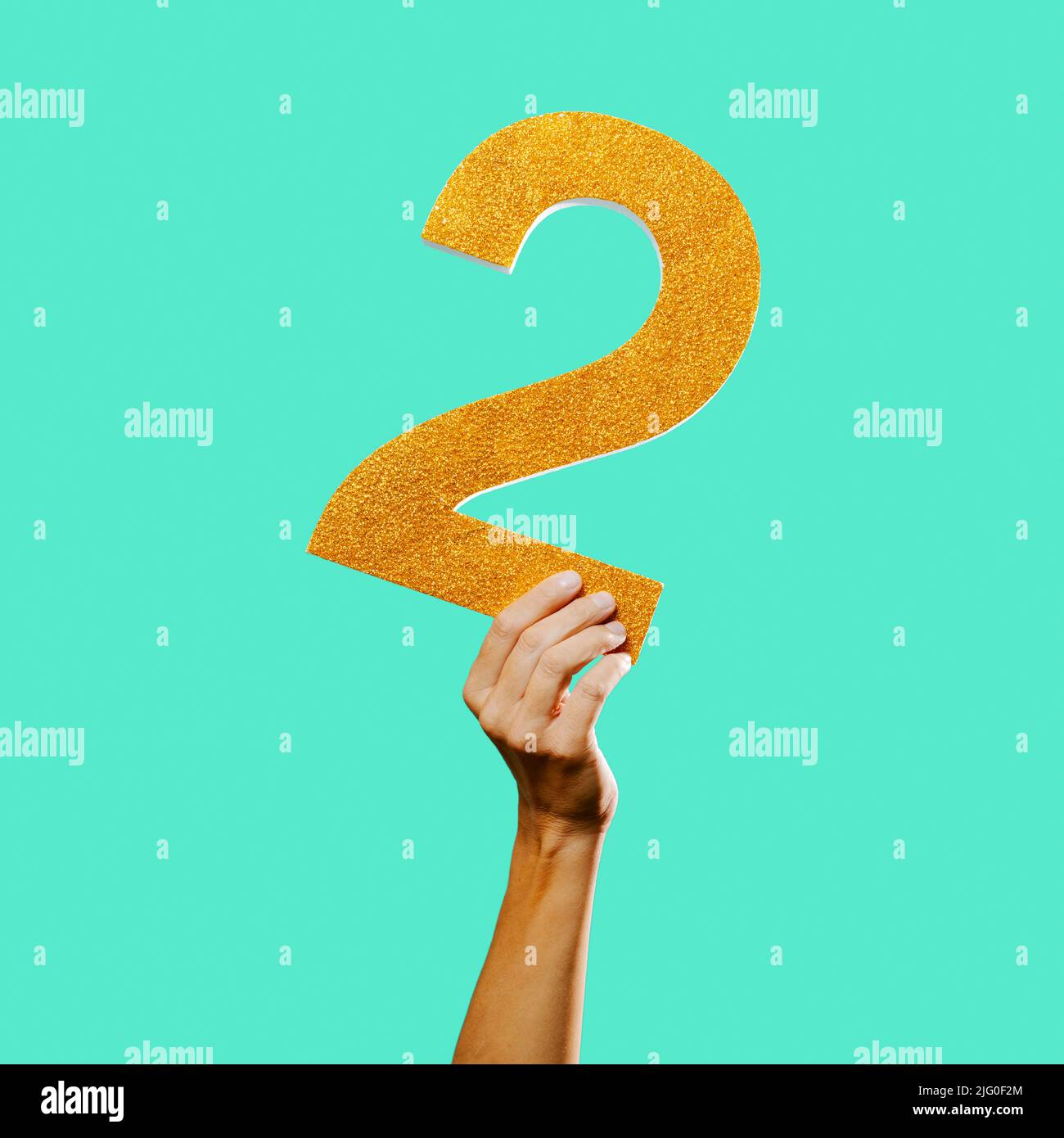 a man shows a three-dimensional number 2 against a greenish blue ...