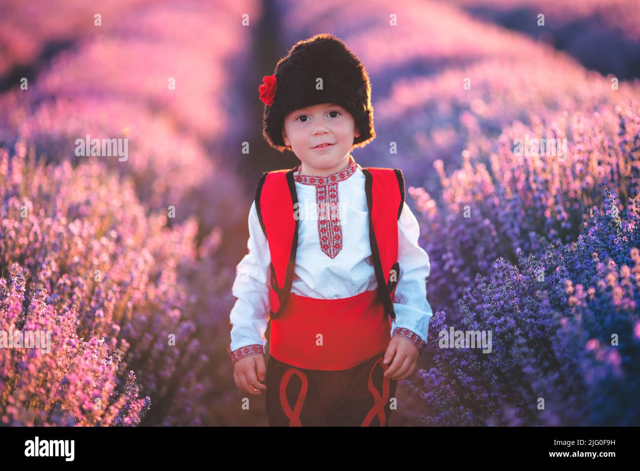 Baby boy in traditional Bulgarian folklore costume in lavender field ...