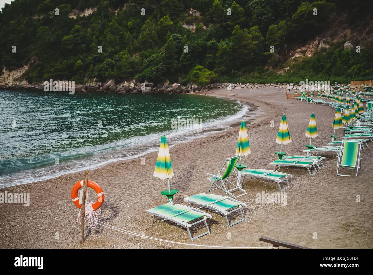 Sun loungers and umbrellas on the Sassolini beach Stock Photo - Alamy