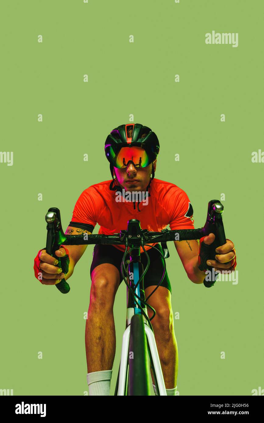Front camera view of sportsman, cyclist on bicycle in red sports ...
