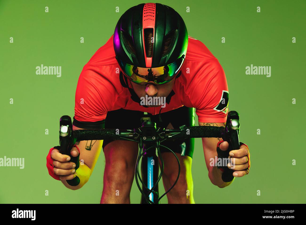 Front camera view of sportsman, cyclist on bicycle in red sports ...