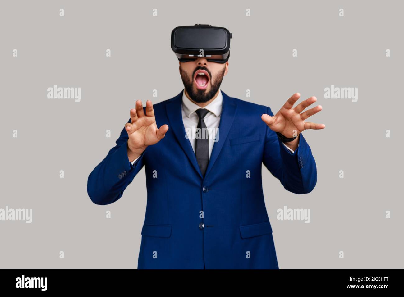 Bearded man in vr headset, playing virtual reality game with shocked ...