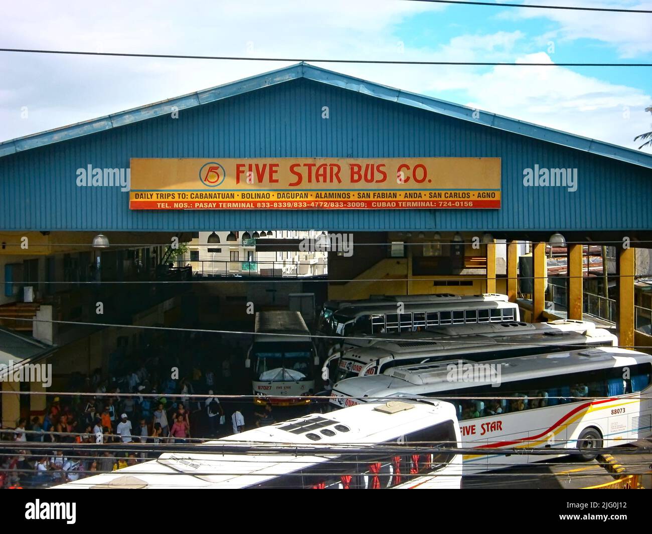 The Five Star Bus Co. station terminal with rows of busses parked below ...