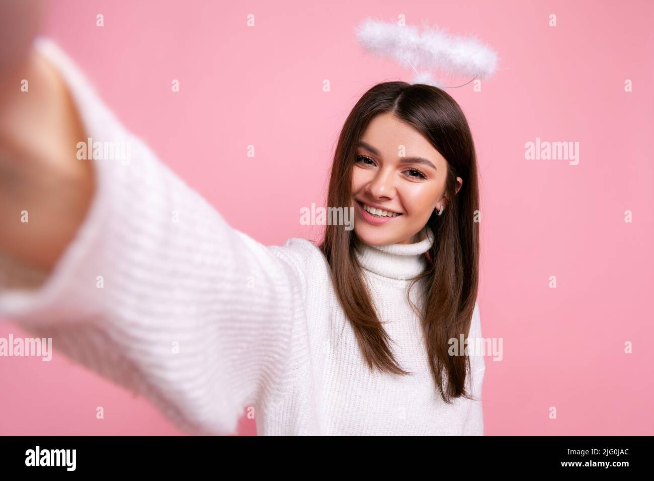 Angelic female with nimb over her head making point of view photo ...