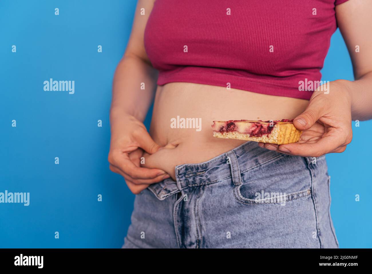 Overweight girl holding her hand to her side Stock Photo - Alamy