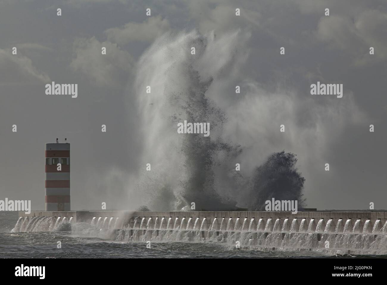 Soft backlit wave splash, spray and moisture on a stormy day. Douro ...