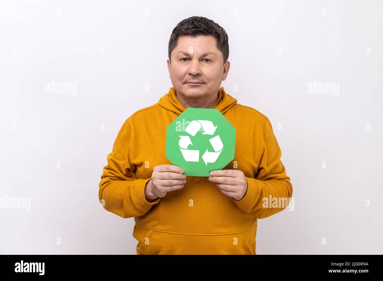 Positive smiling man with dark hair showing green waste recycling ...