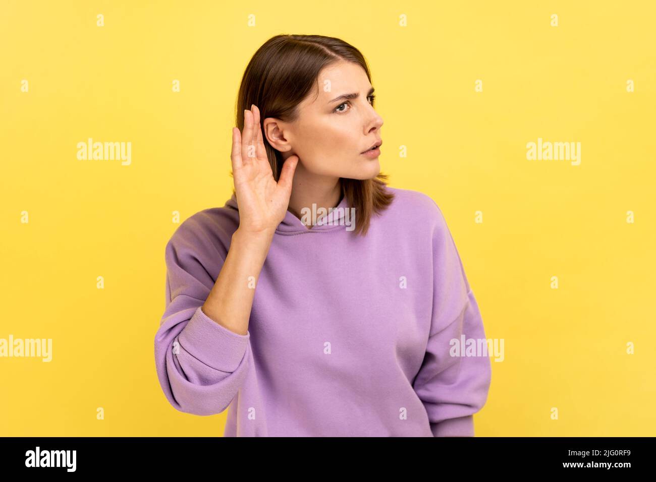 Woman with hand to ear hi-res stock photography and images - Alamy