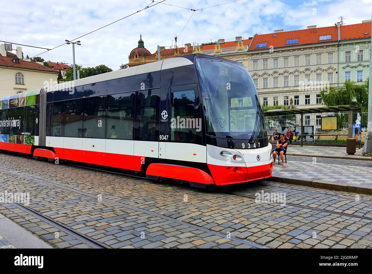 Tram on street in Prague. A modern tram rides through old town in ...