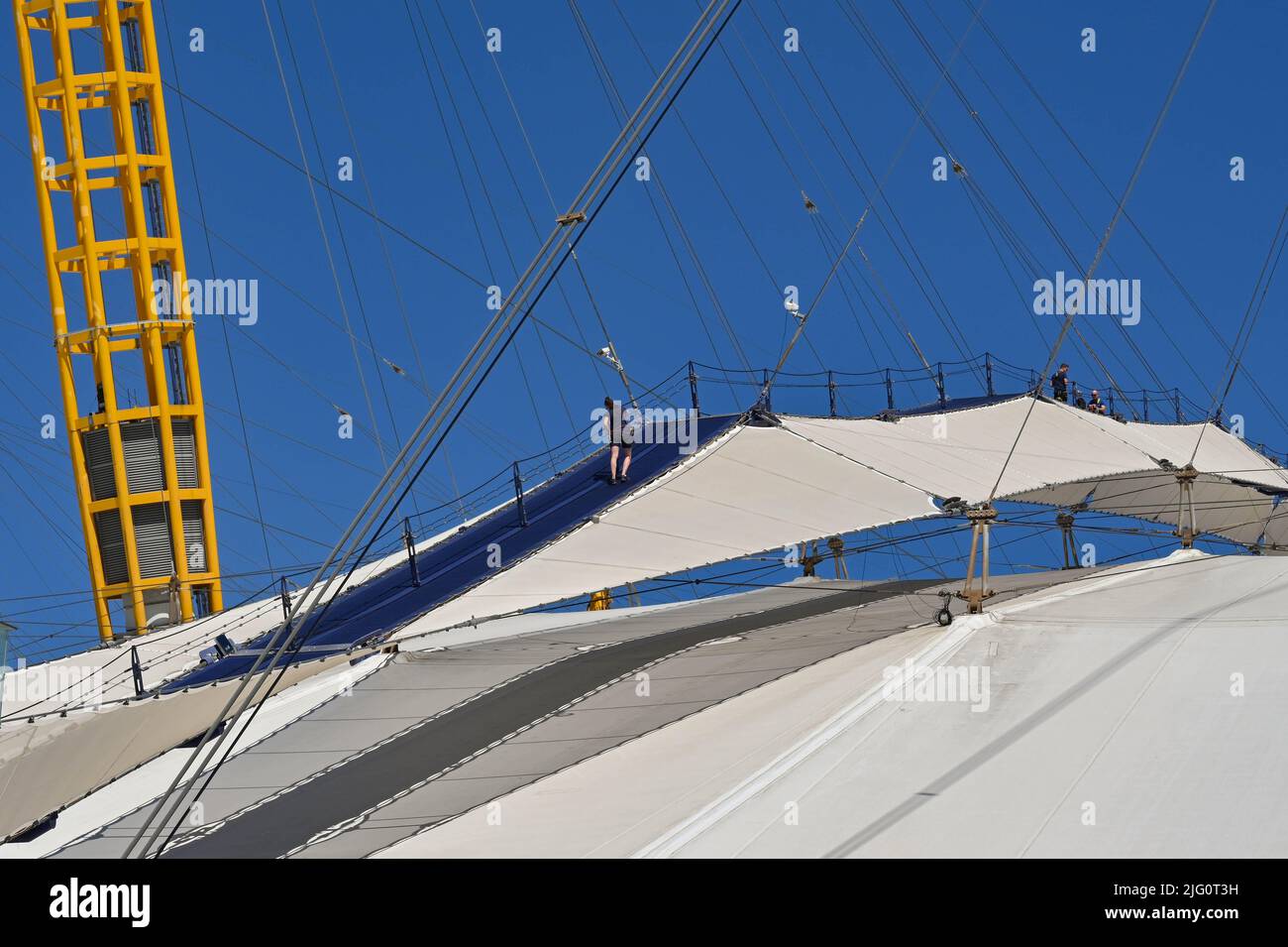 London, England - June 2022: Person climbing the roof of the O2 arena ...