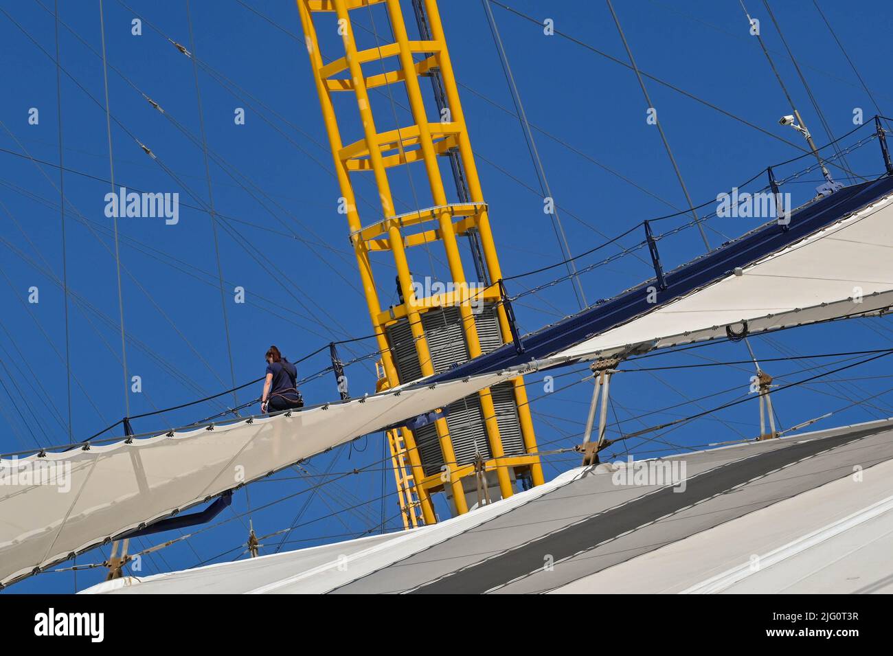 London, England - June 2022: Person climbing the roof of the O2 arena ...