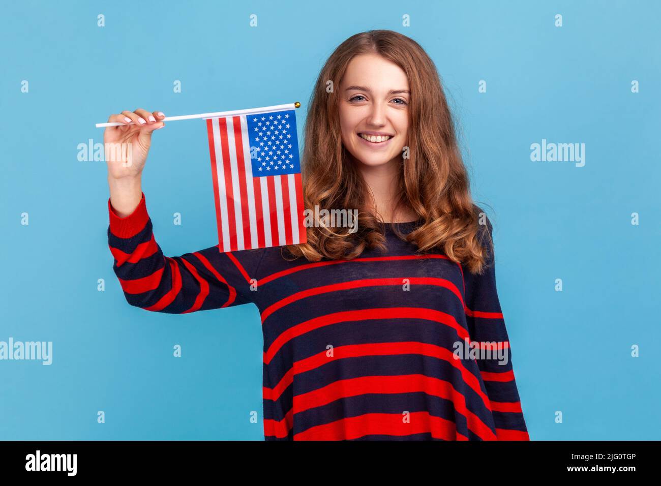 Good looking woman wearing striped casual style sweater, waving united ...