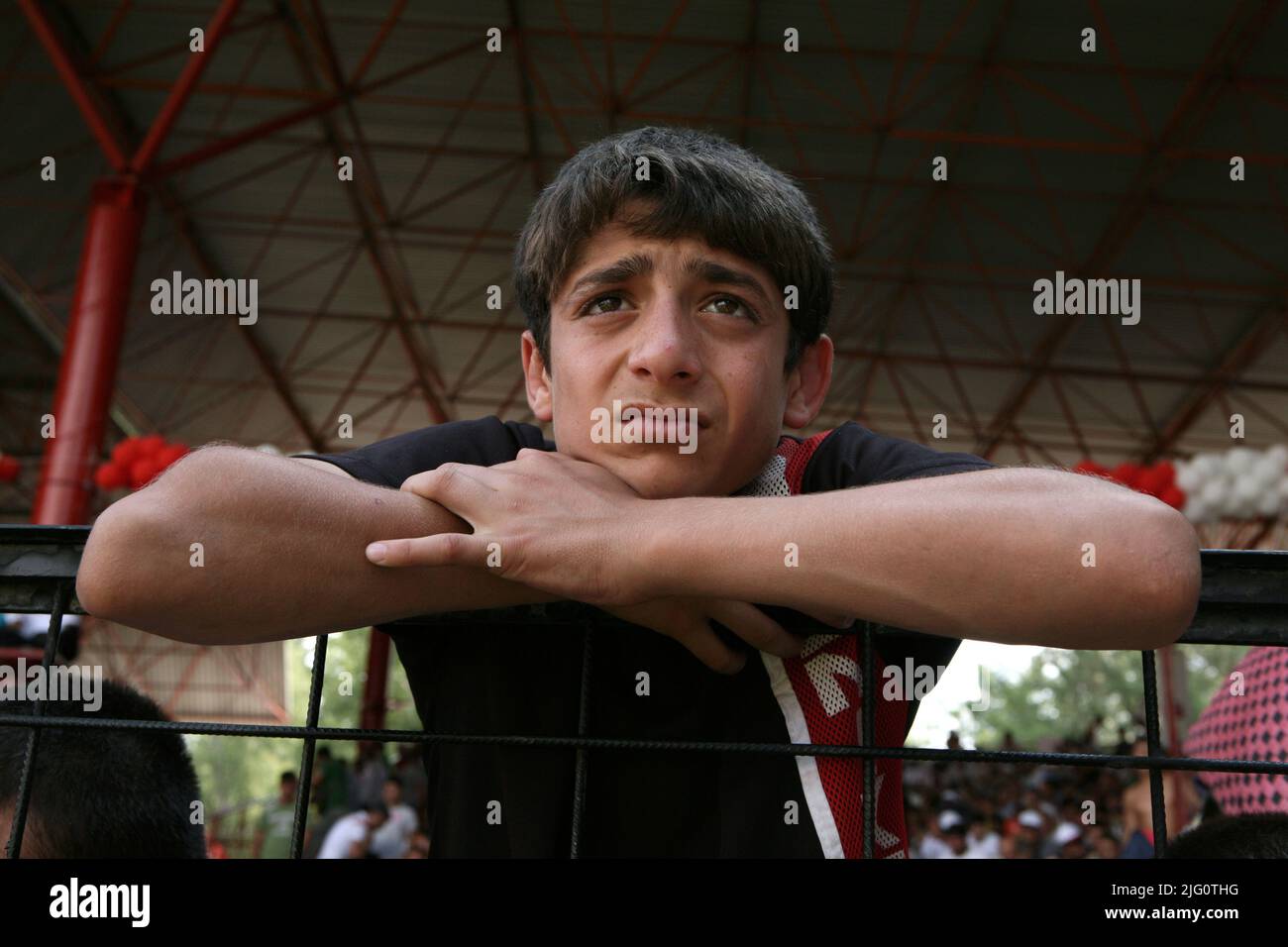 Kırkpınar (Turkish Oil Wrestling). Young boy watches as wrestlers fight ...