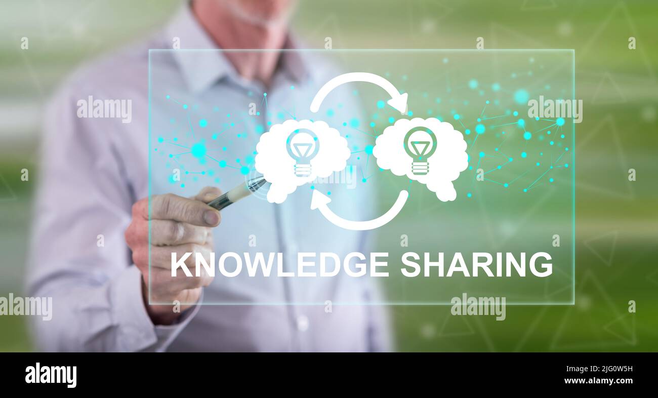 Man touching a knowledge sharing concept on a touch screen with a pen ...