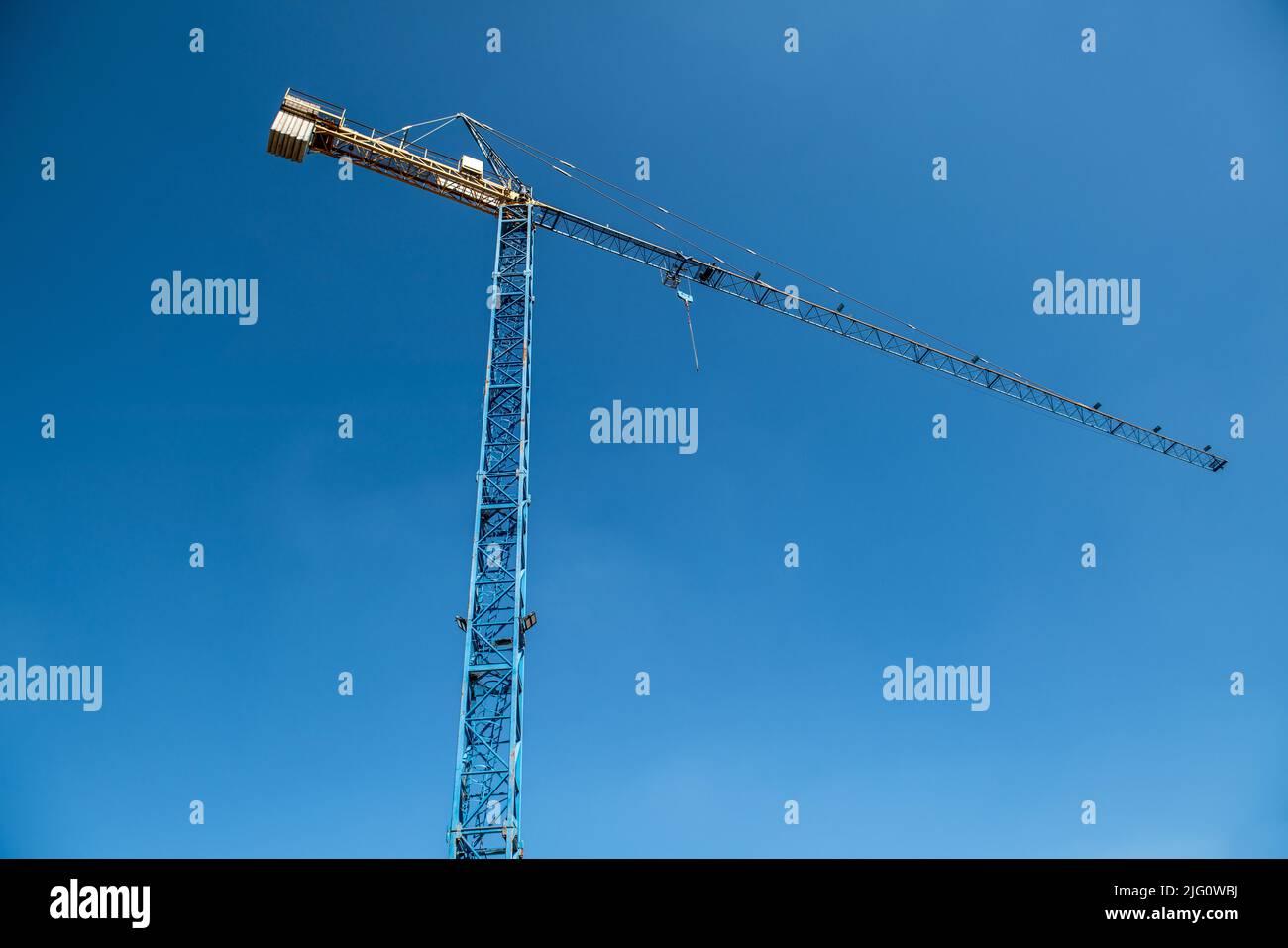 construction of a building: the tower crane with its hook transports ...