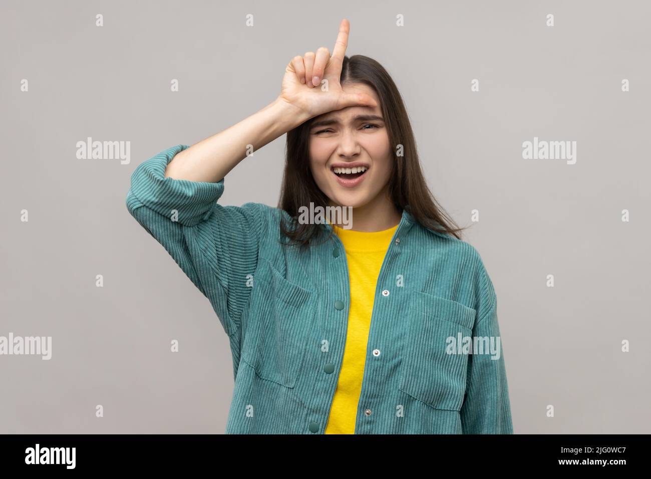 I lost job. Portrait of depressed woman showing loser gesture, L finger ...