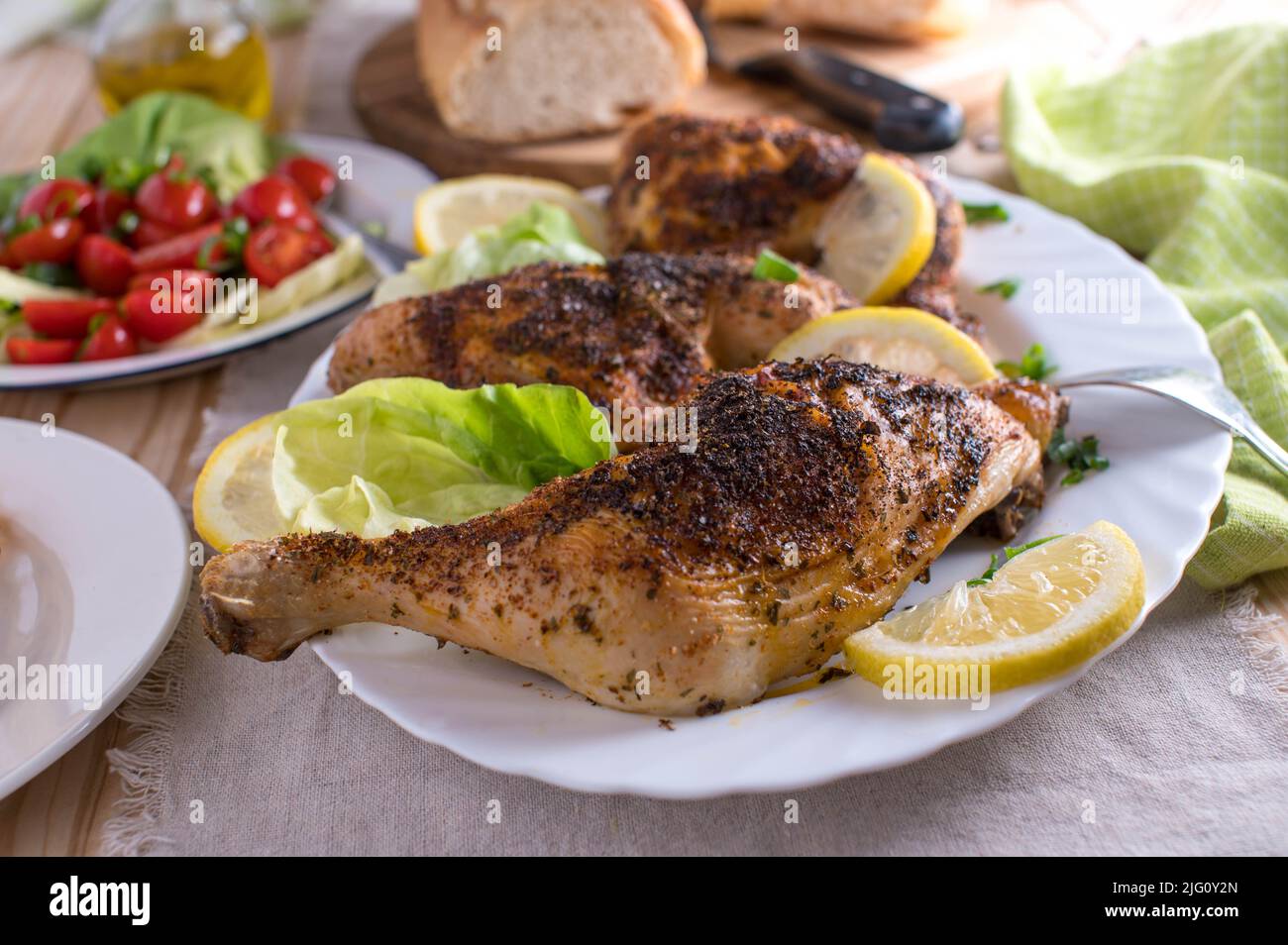 Crispy chicken legs with salad and bread Stock Photo - Alamy