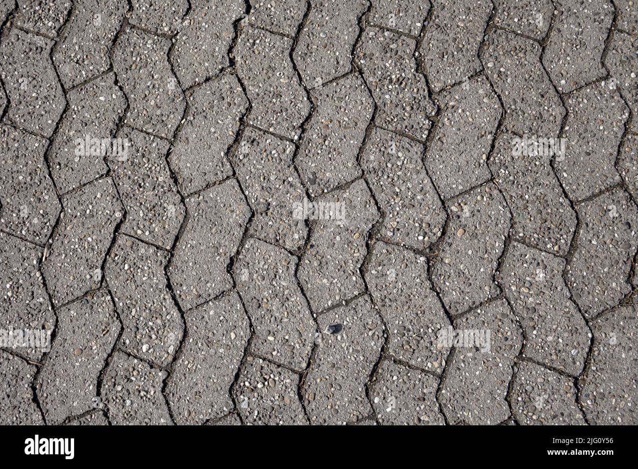 old concrete paver brick on a street surface. Made from concrete for ...